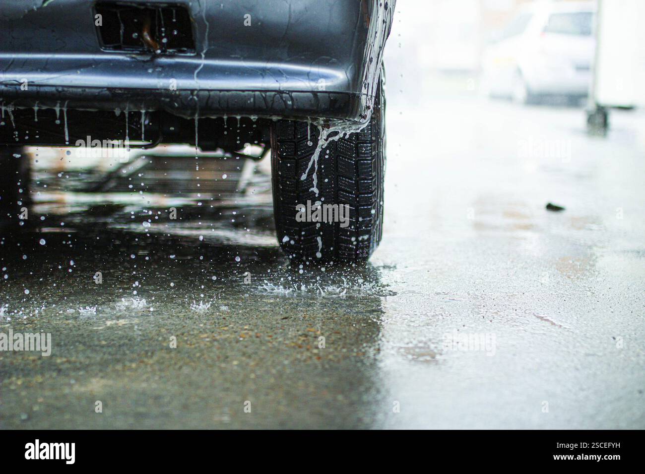 Dripping water from car tire on wet surface during a wash Stock Photo ...