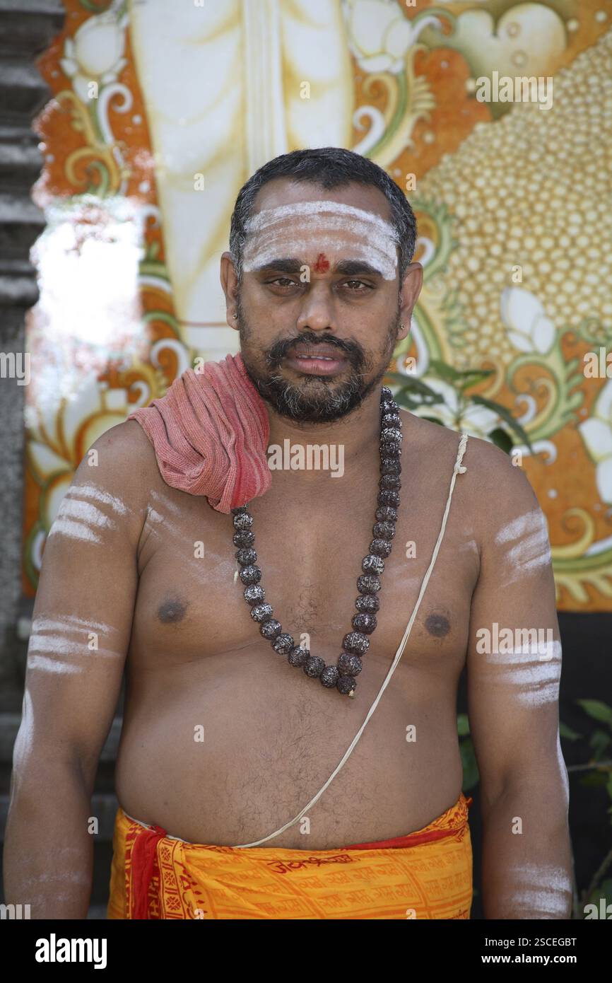 Religious preacher wearing rudraksha mala applying holy ash or bhasma ...