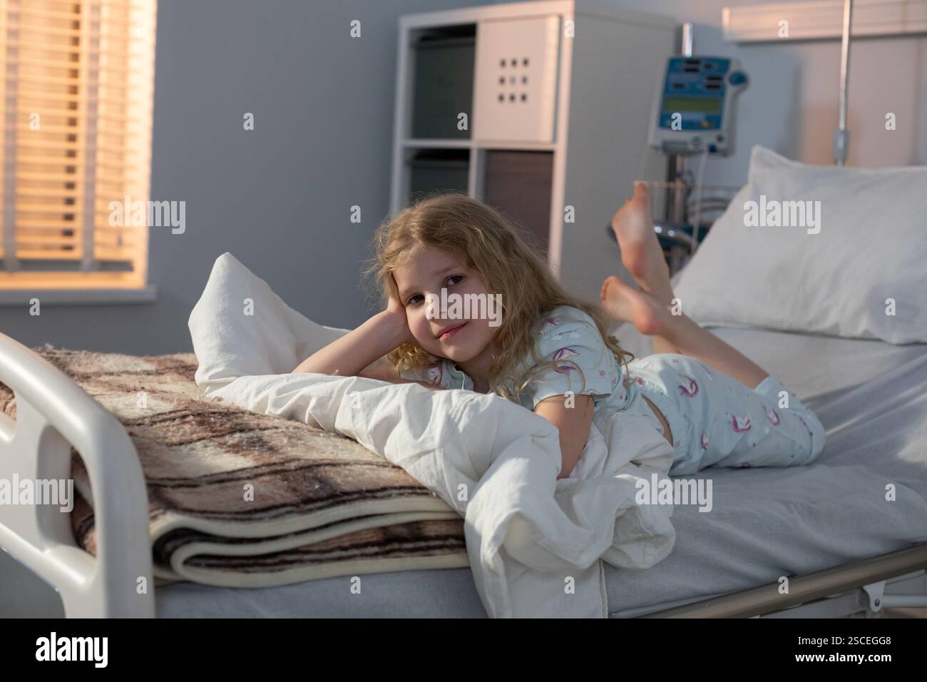 A tender and comforting scene depicts a child lying in a hospital bed ...