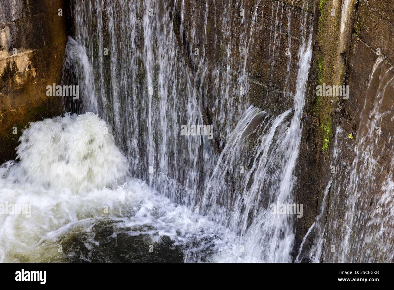 a leaking wooden dam with a lot of holes, old wooden fences with ...
