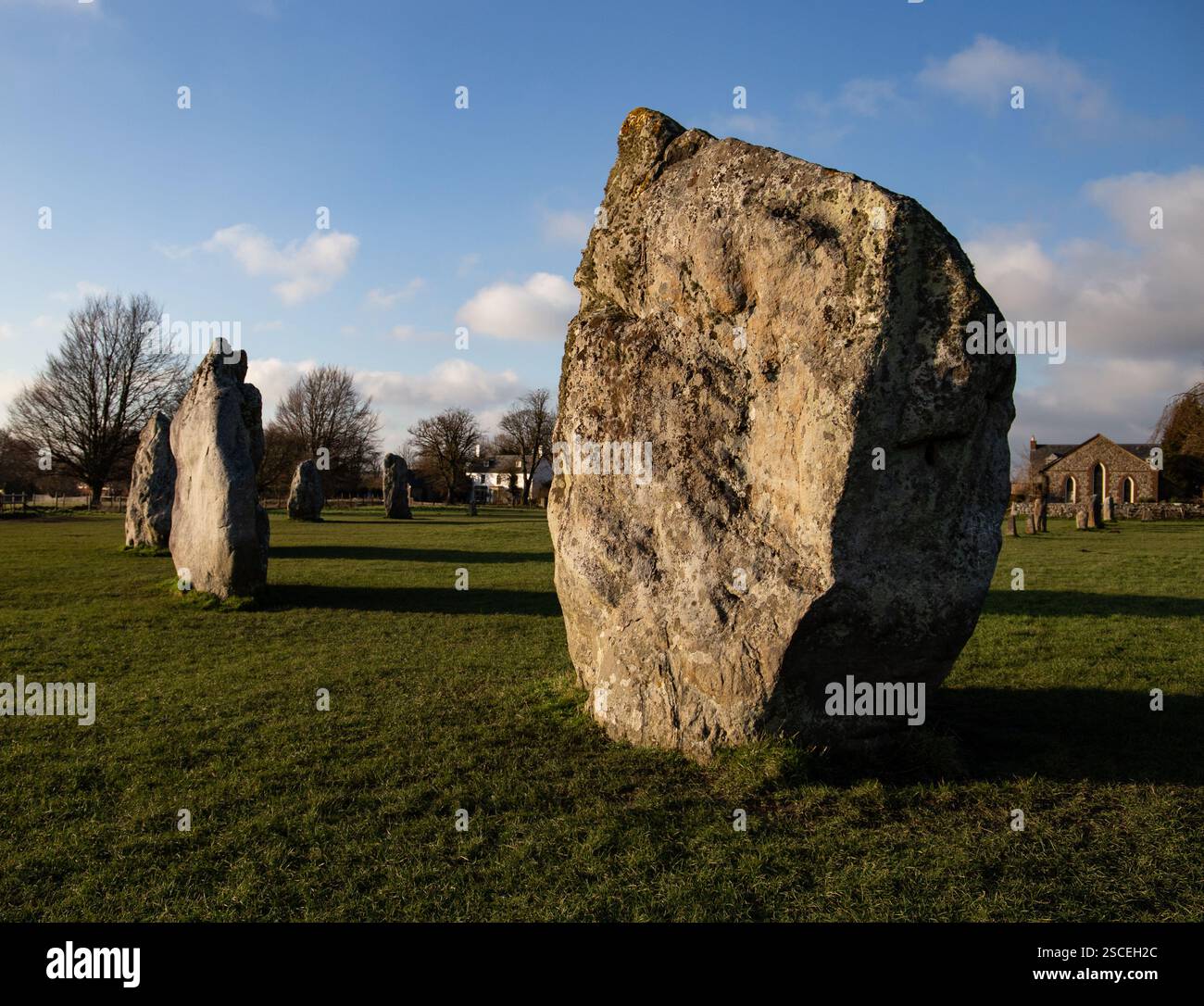 Avebury ancient Neolithic standing stones at in a grassy field under a ...