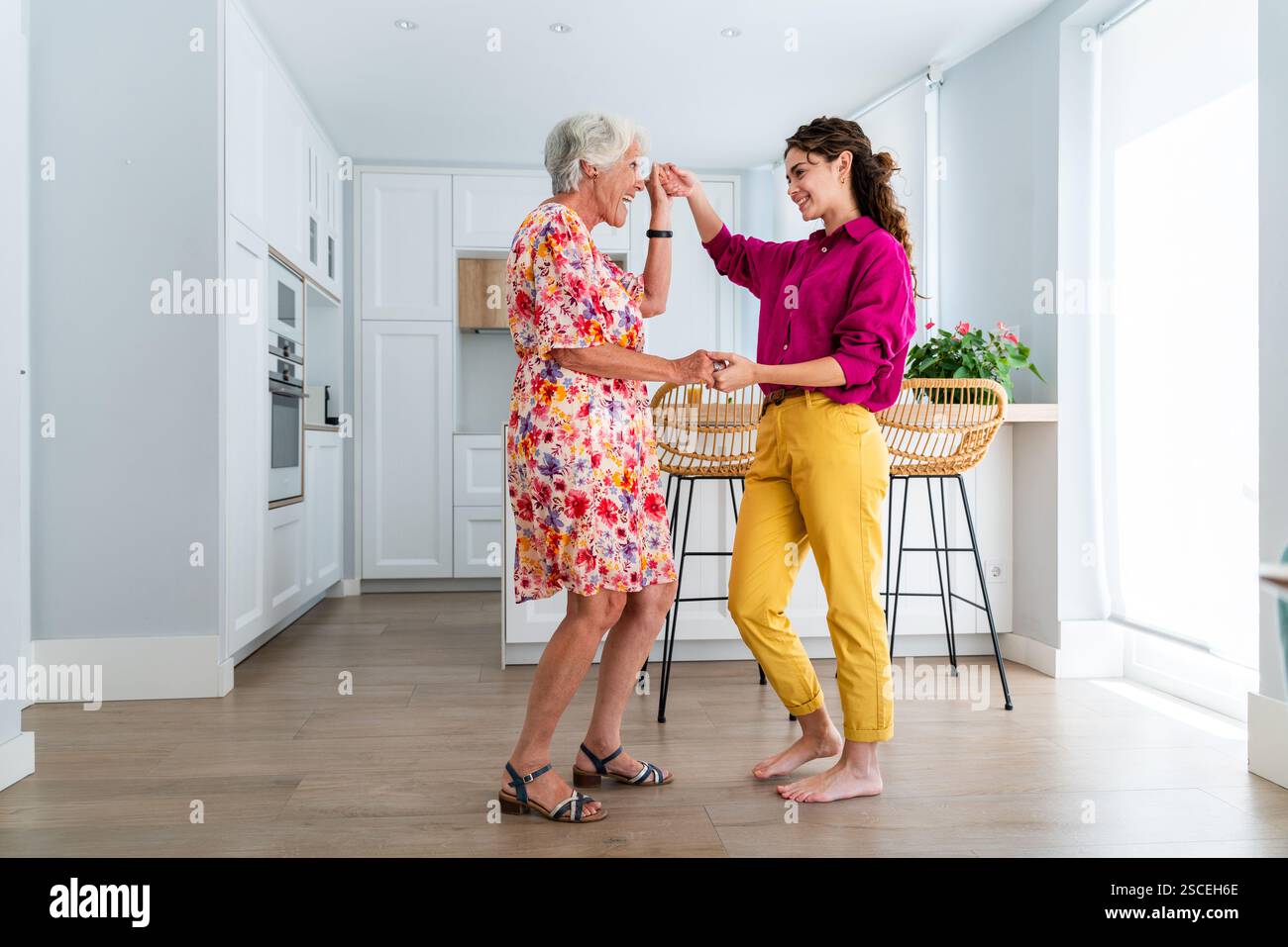 Beautiful grandmother and granddaughter together at home having fun ...