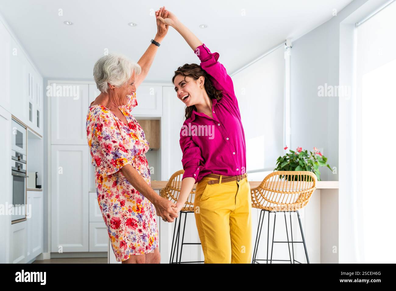 Beautiful grandmother and granddaughter together at home having fun ...
