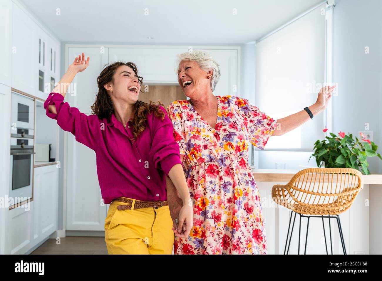 Beautiful grandmother and granddaughter together at home having fun ...