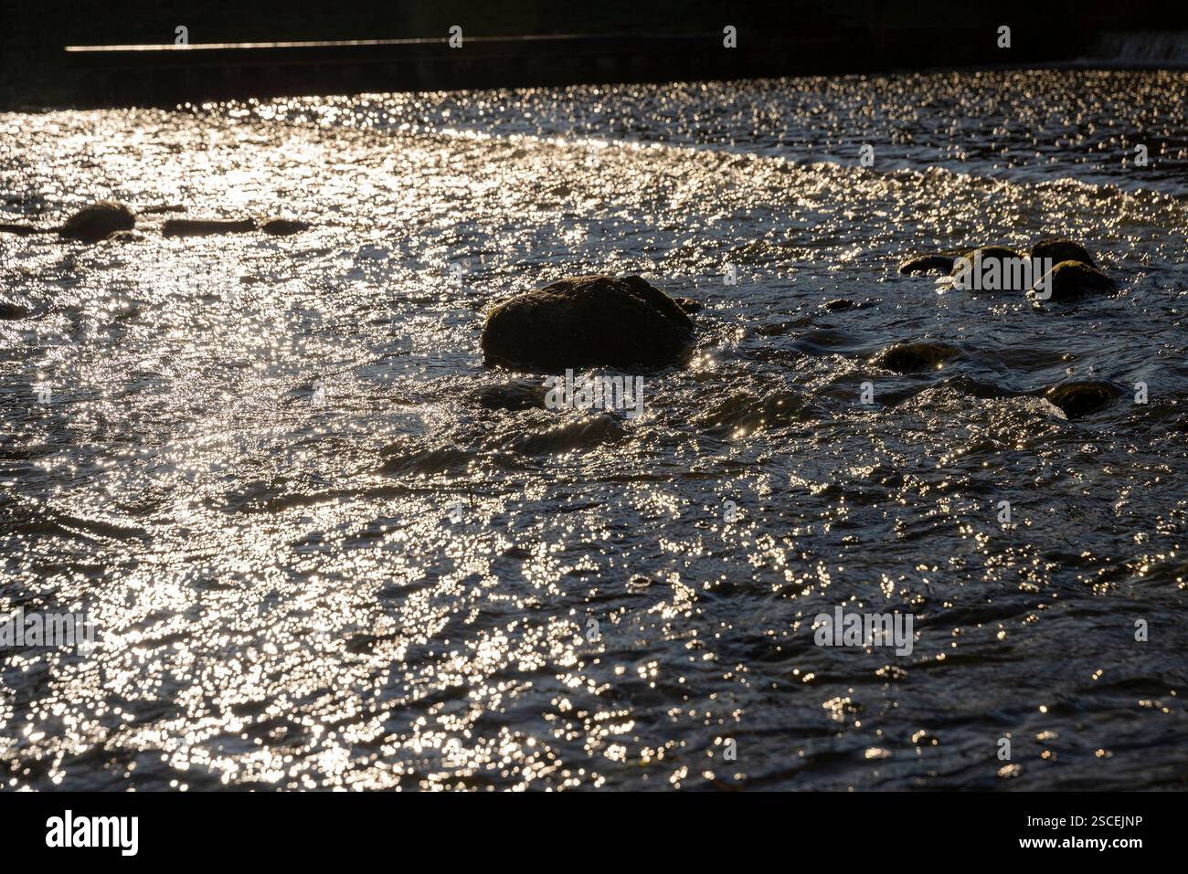 a wide but shallow river with a large current , part of a river with a ...