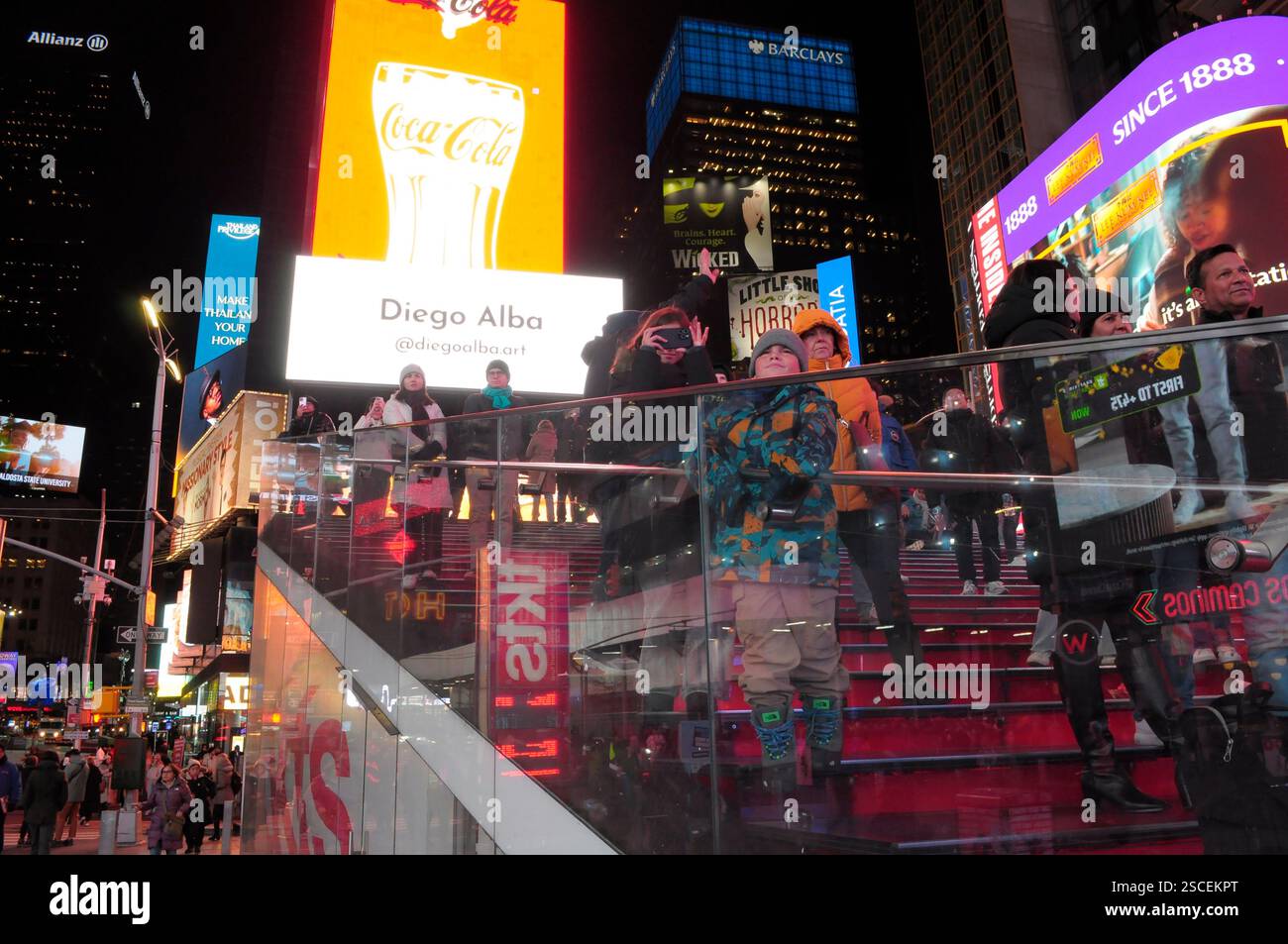 People are seen on the red stairs in Times Square, Manhattan, New York ...