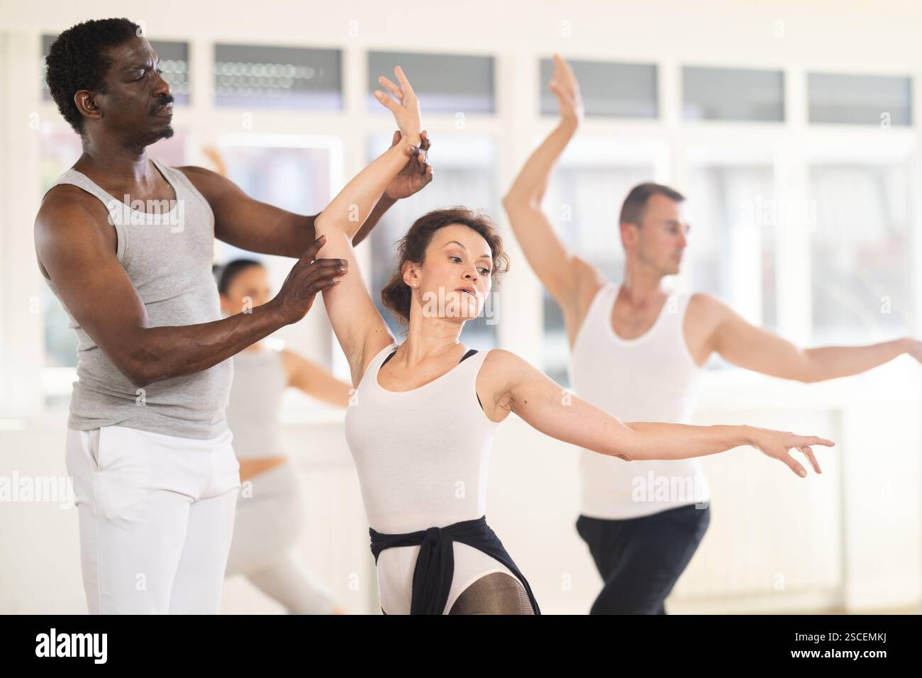 Male trainer teaches group ballet movements Stock Photo - Alamy