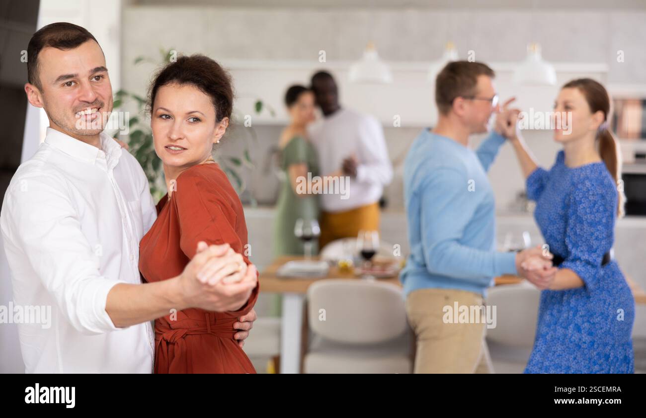 Friends party - men and women of different nationalities dancing slow ...