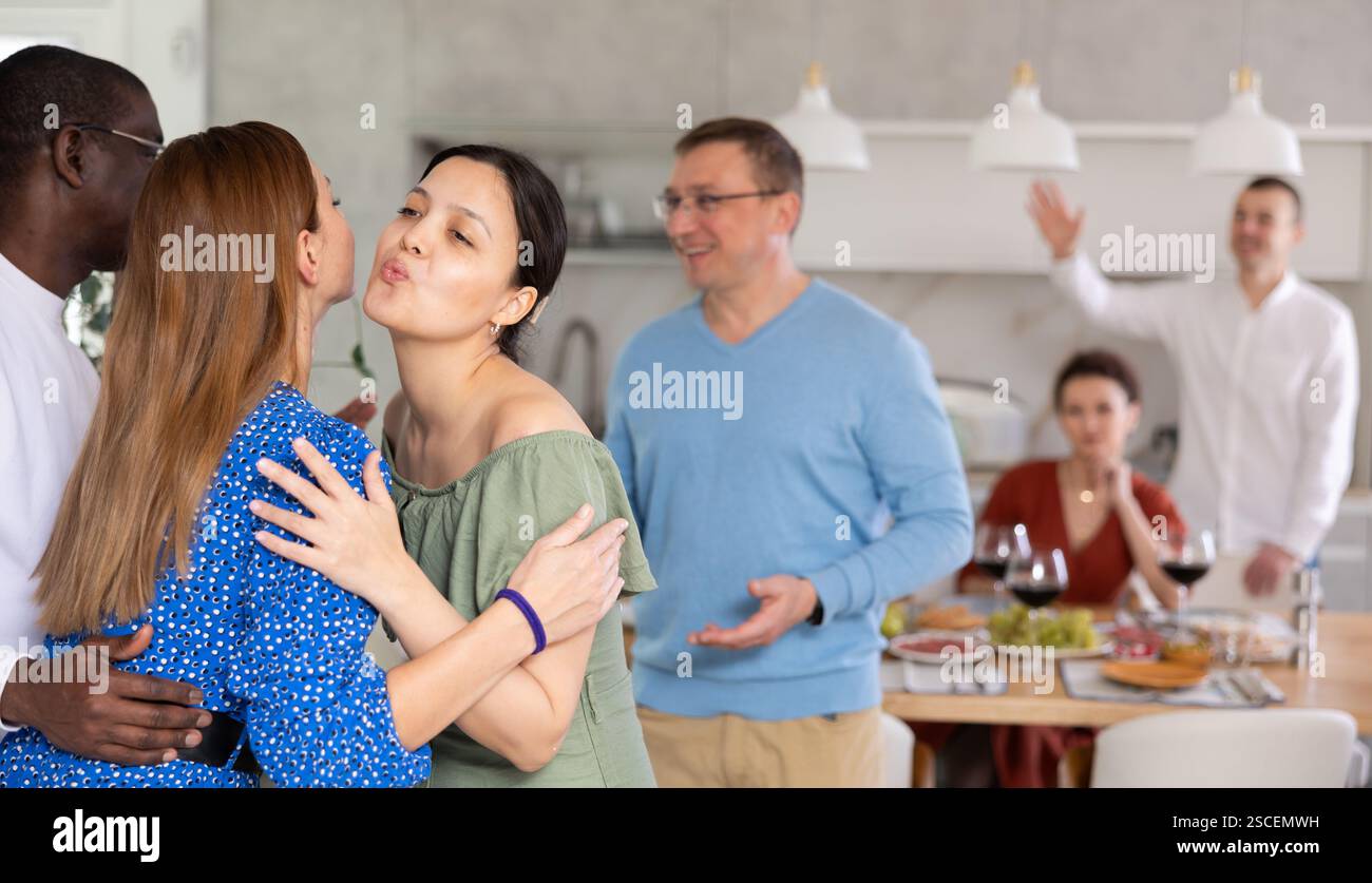 Two women greet each other when meeting Stock Photo - Alamy