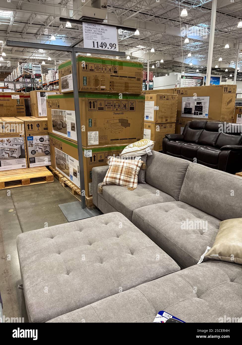 Large sectional sofa display at warehouse store Stock Photo - Alamy