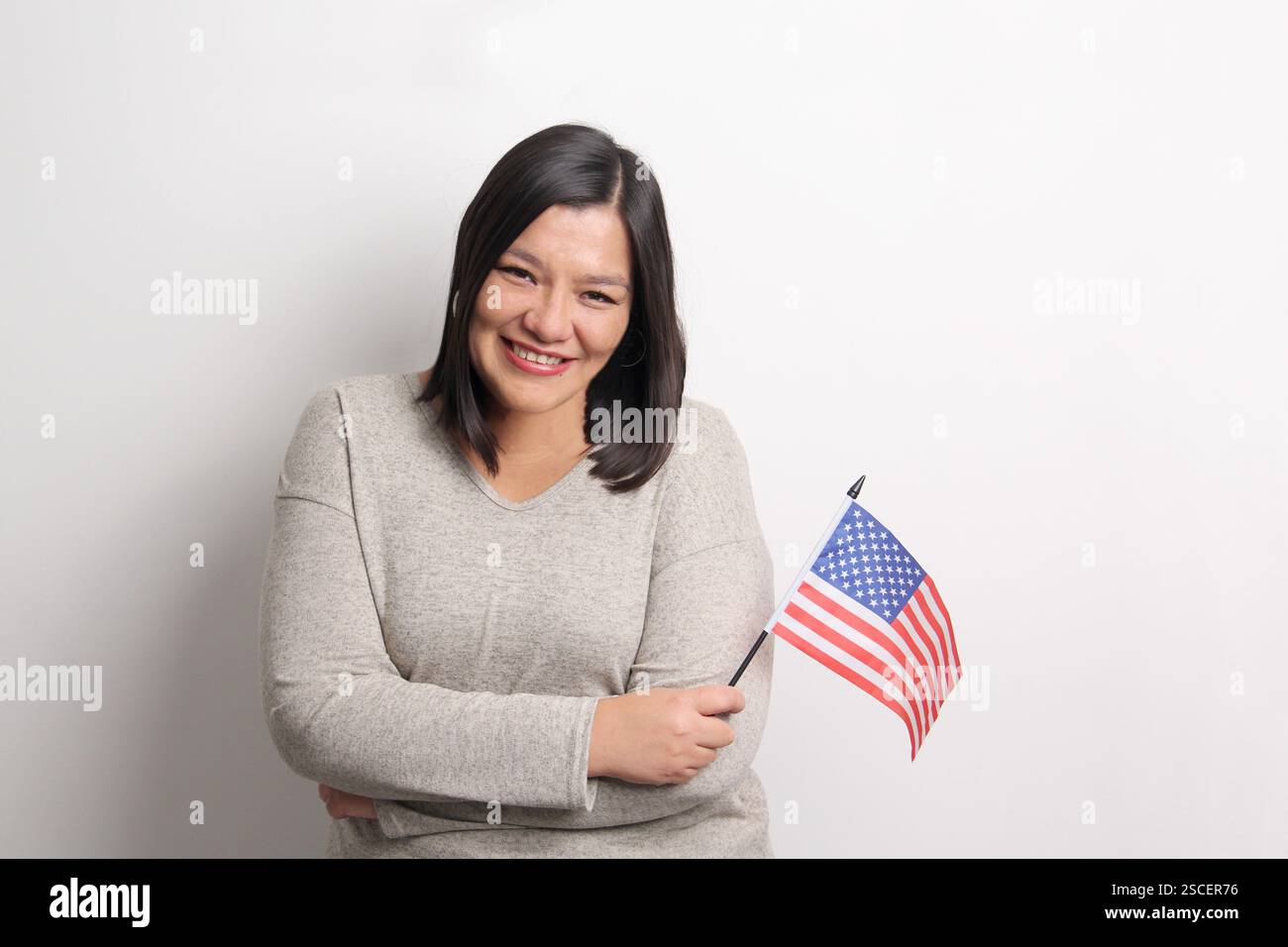 40-year-old Latina woman shows the United States flag proud and happy ...
