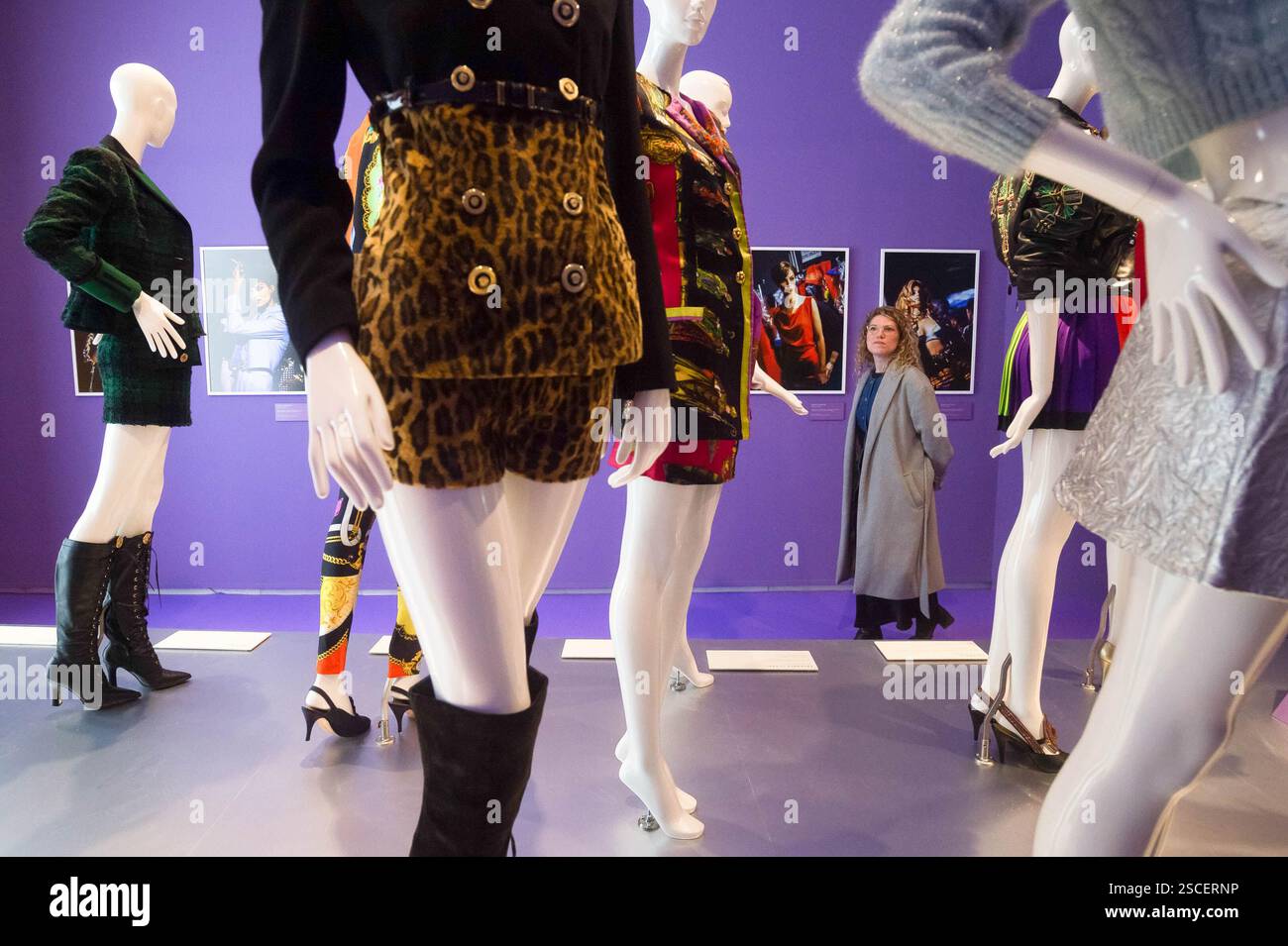 A woman is seen walking past the creations of Italian fashion designer ...