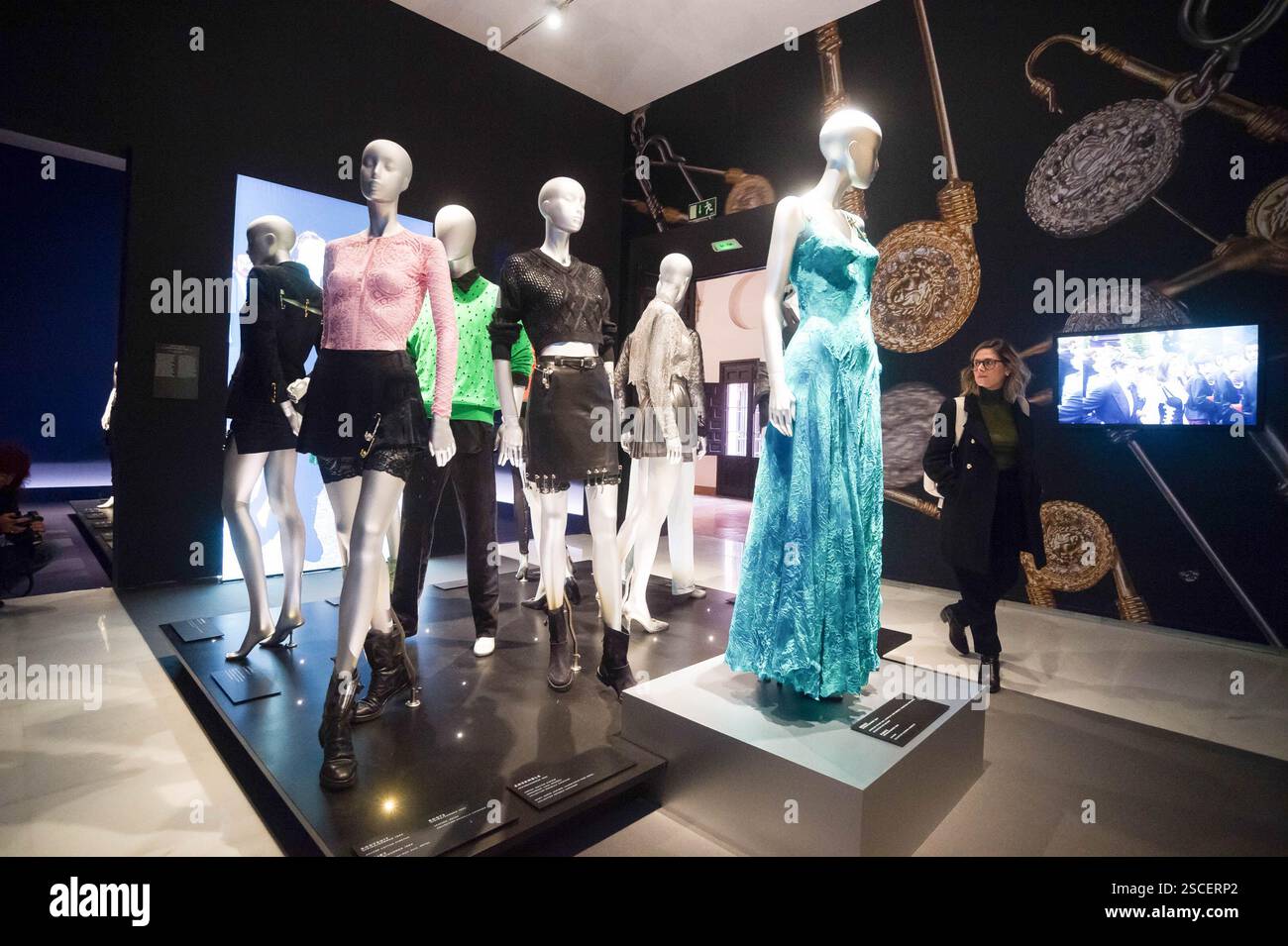 A woman is seen walking near the creations of Italian fashion designer ...