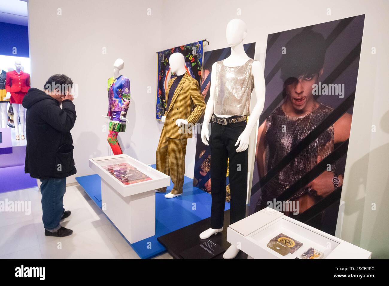 A man is seen looking at the creations of Italian fashion designer ...