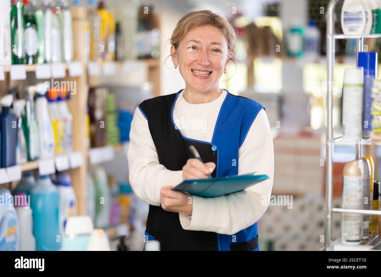 Female manager of hardware store keeps track of goods on supermarket ...