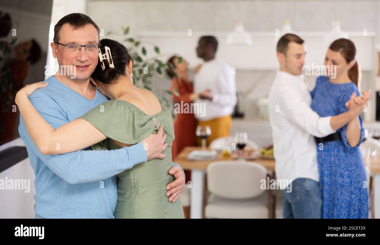 Men and women of different nationalities having fun dancing slow dance ...