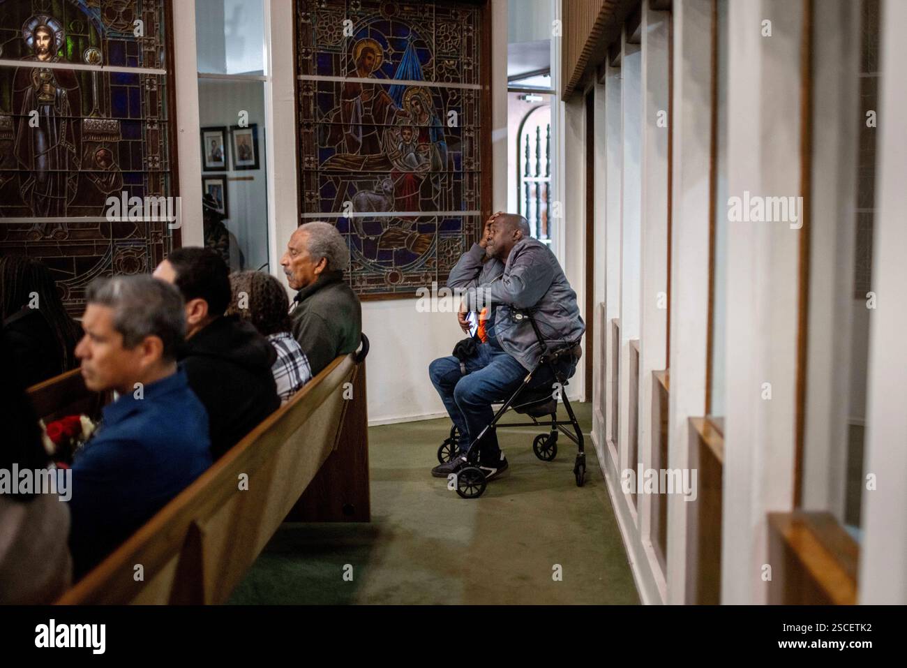 People attend a memorial service for fire victims at the First AME ...