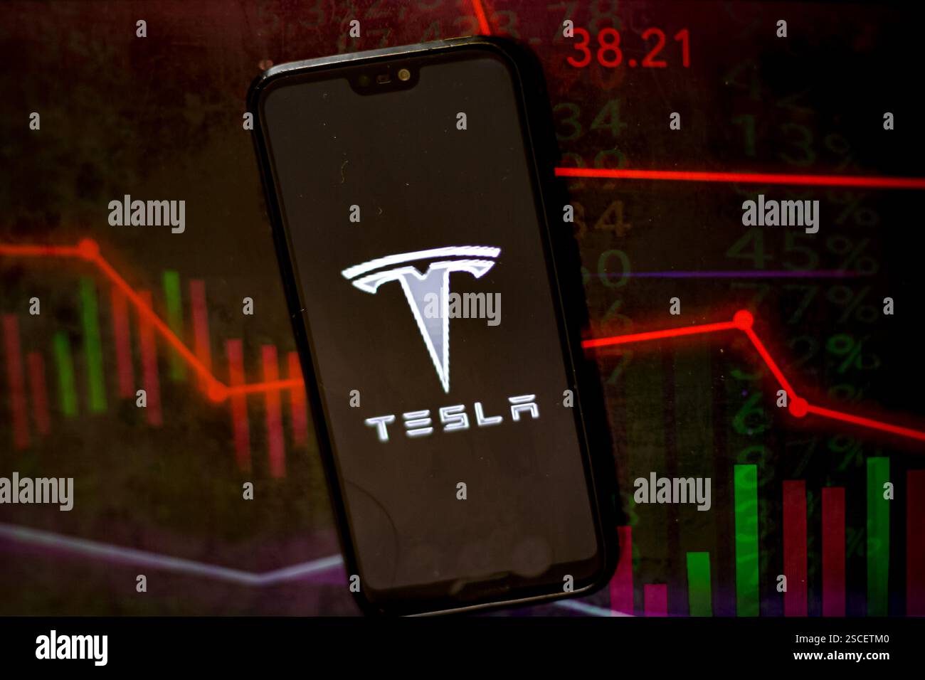 In this photo illustration, the Tesla logo is seen displayed on a ...