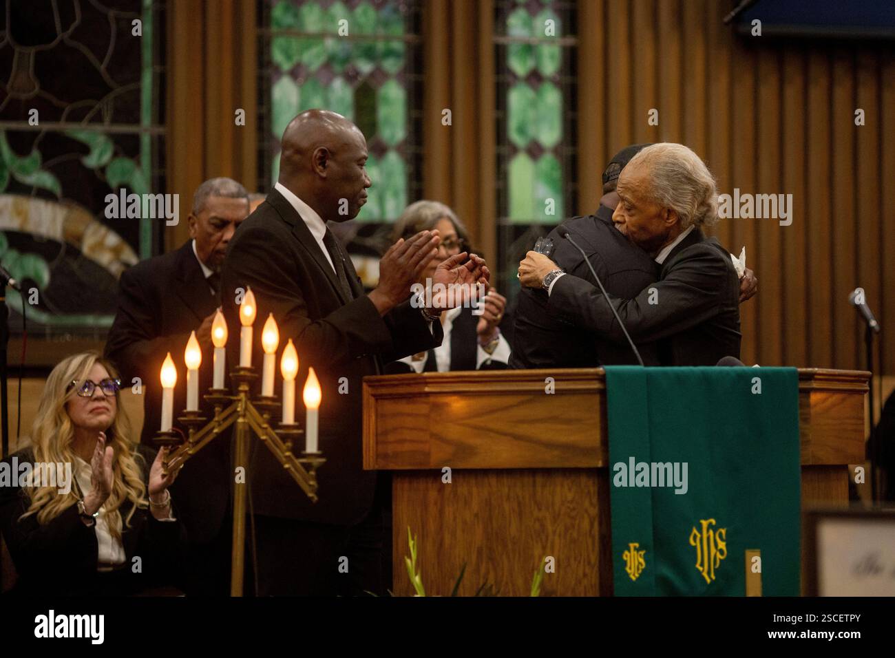Zaire Calvin, who lost his sister in the Eaton Fire, is embraced by ...
