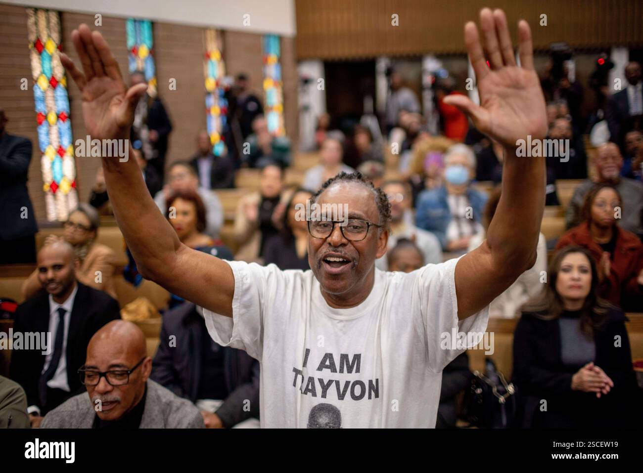 People attend a memorial service for fire victims at the First AME ...