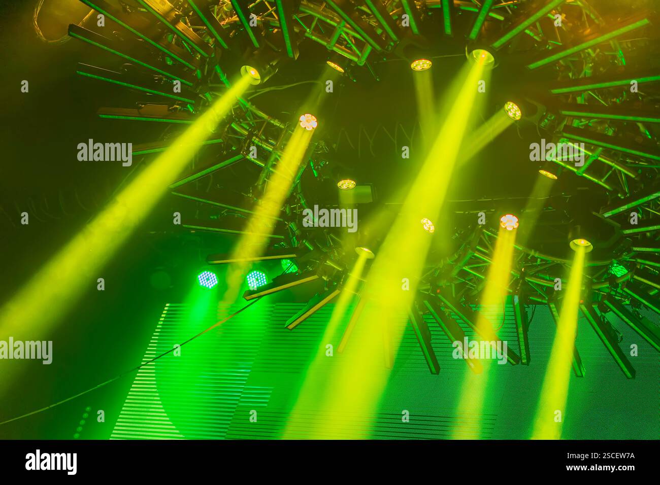 Dynamic yellow stage lights shining from a circular structure with ...