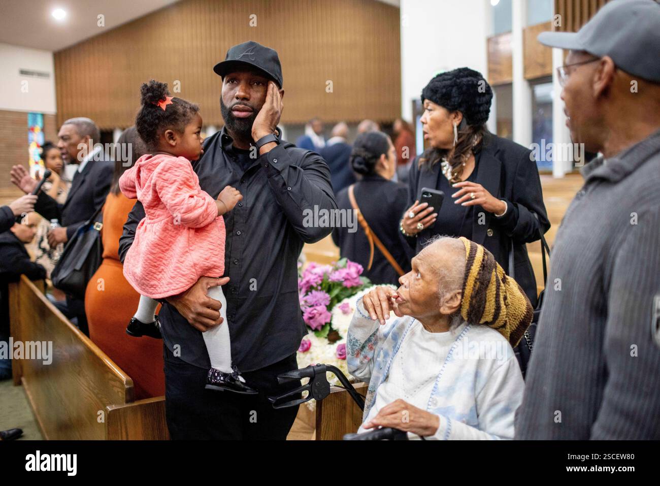 Zaire Calvin, left, who lost his sister in the Eaton fire, wipes his ...