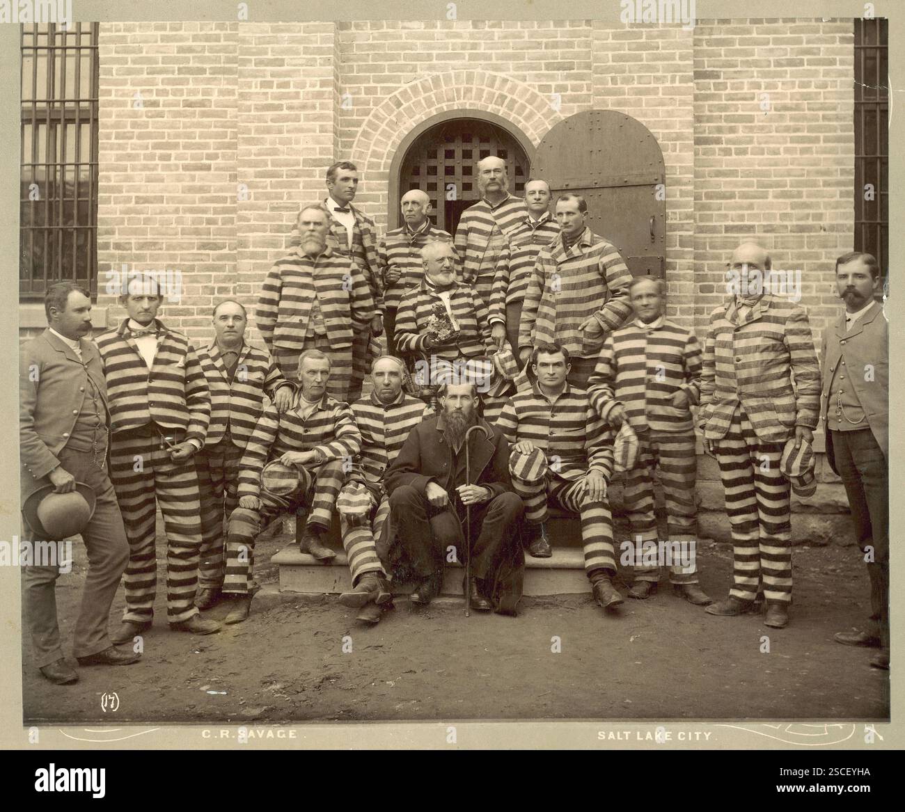 Prisoners in front of jail, Group shot of sixteen men on the steps of a ...