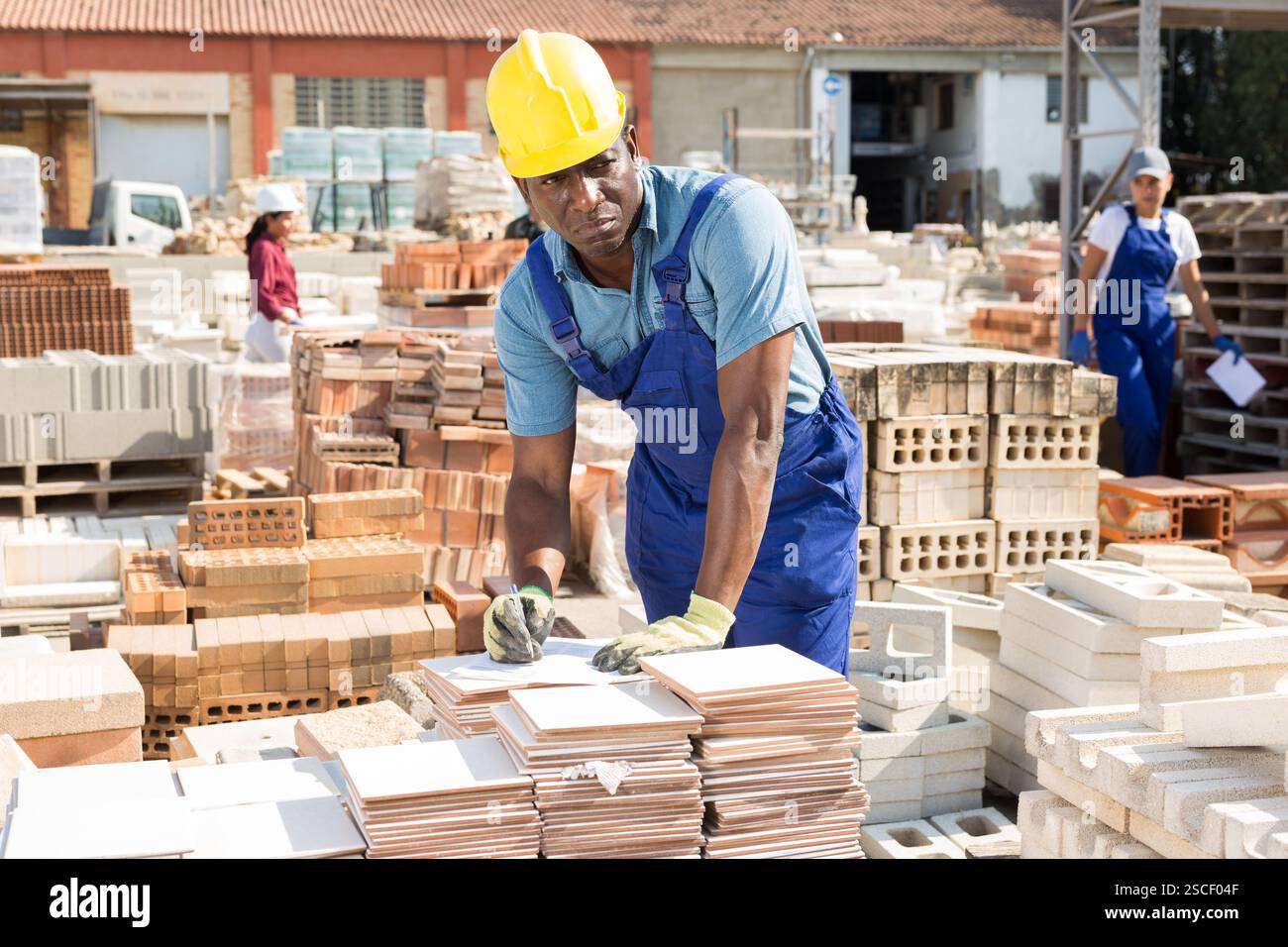 Builder is choosing ceramic tiles in building store Stock Photo - Alamy