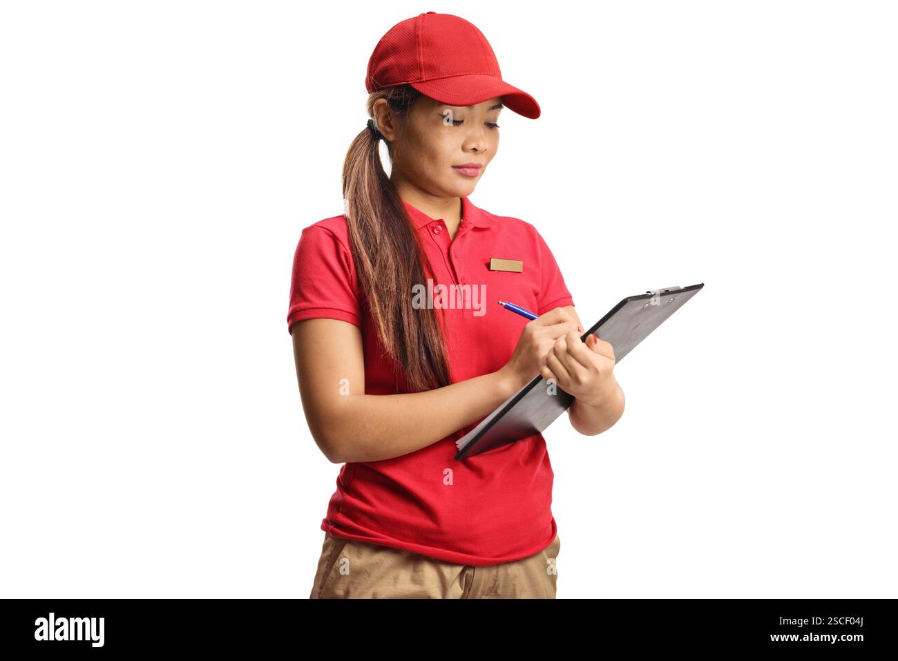 Asian female sales manager holding a clipboard and signing an invoice ...