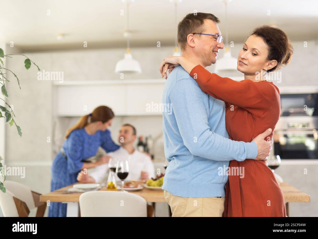 Happy middle-aged men and women doing slow dance in pairs Stock Photo ...