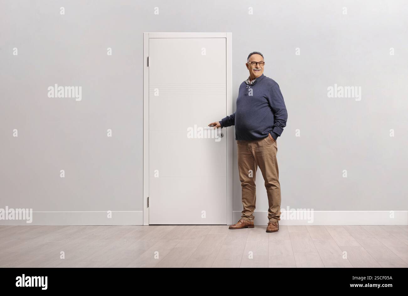 Mature man closing a room door Stock Photo - Alamy