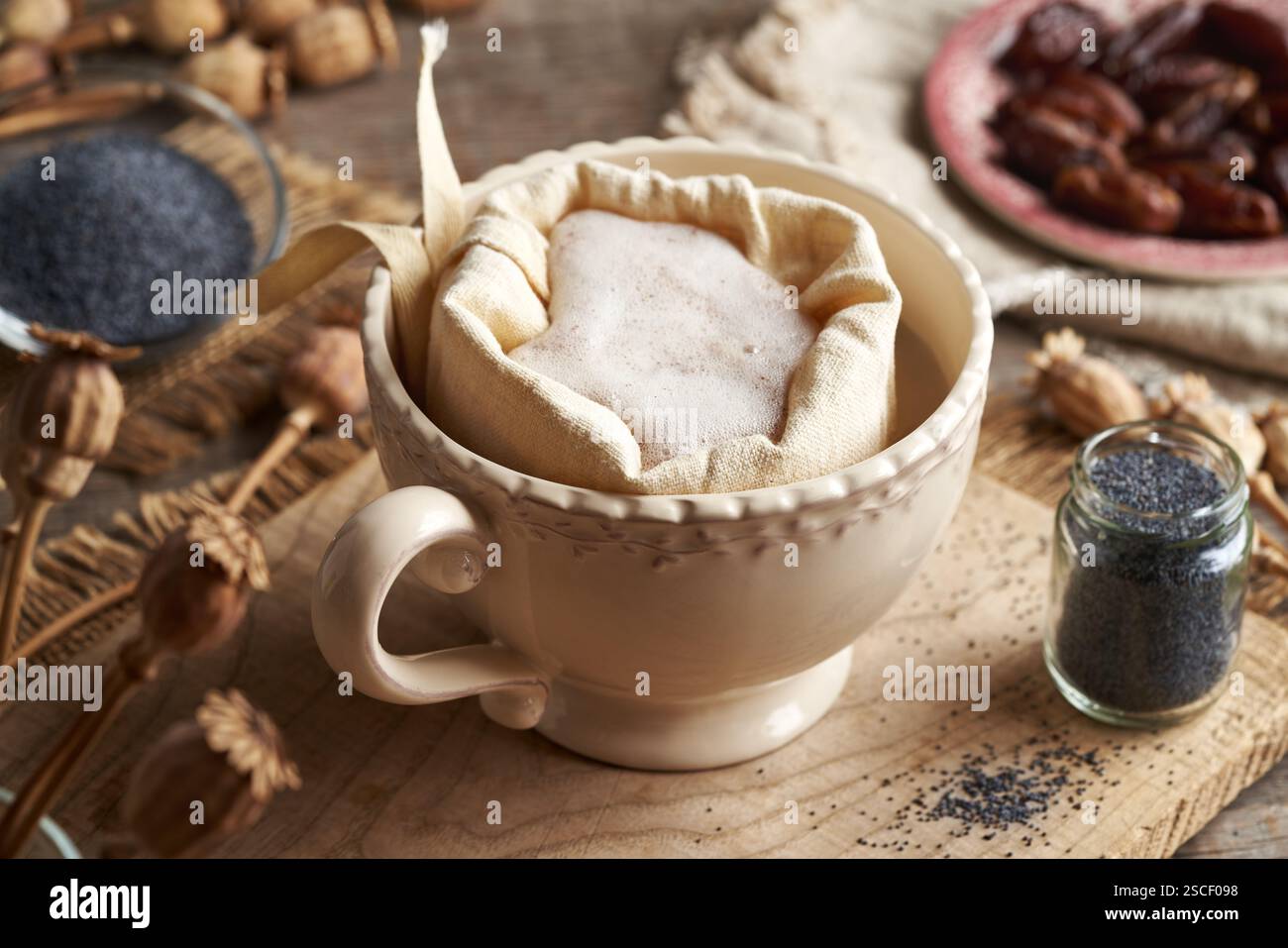 Straining homemade poppy seed milk through a milk bag Stock Photo - Alamy