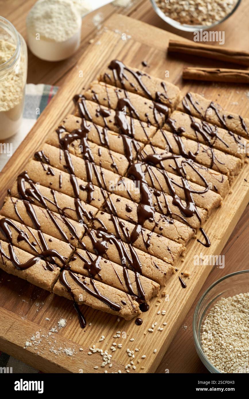 Homemade healthy bars made of whey protein powder, oat flakes, sesame ...