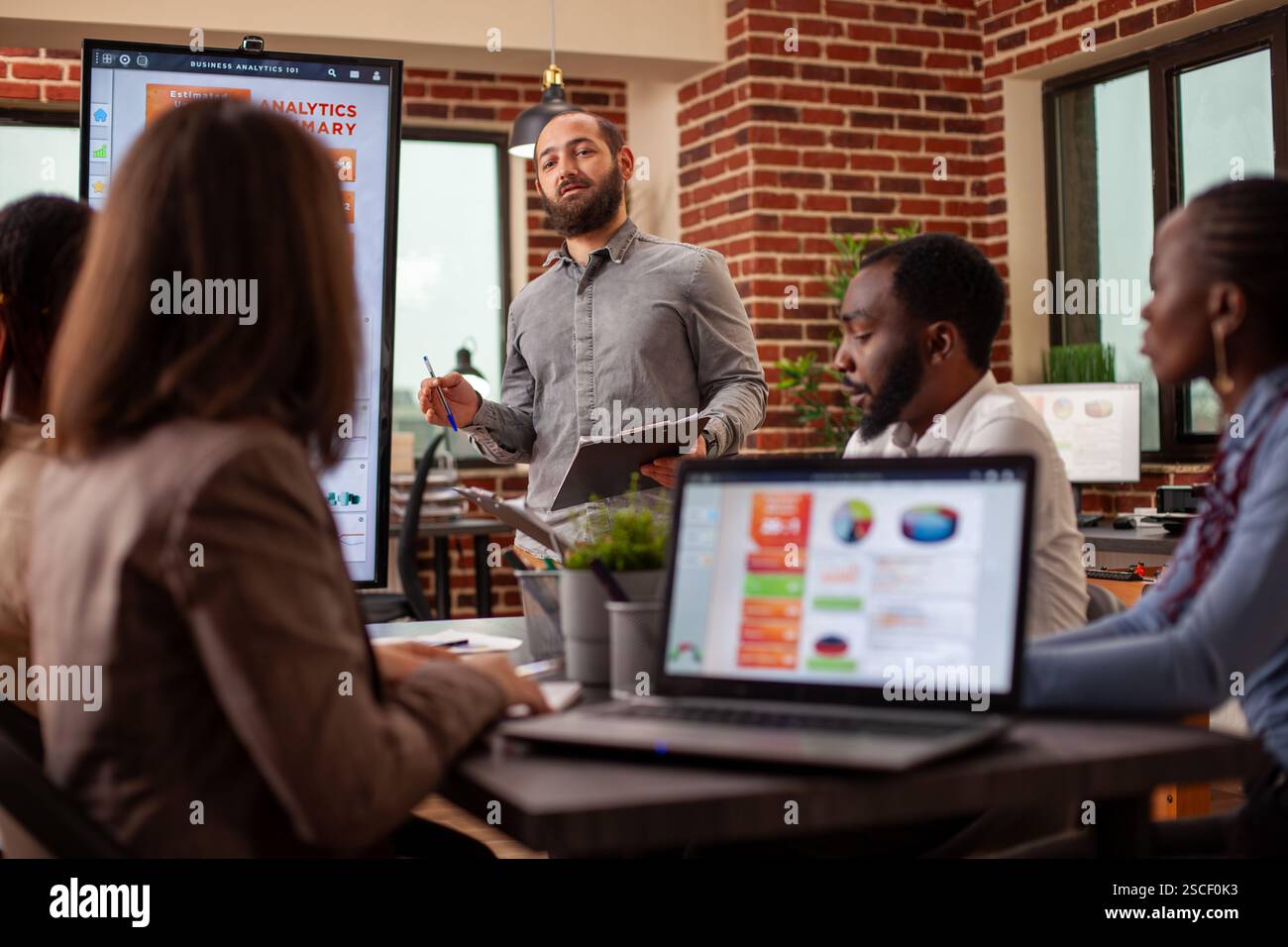 Bearded businessman sharing startup strategy ideas with diverse ...