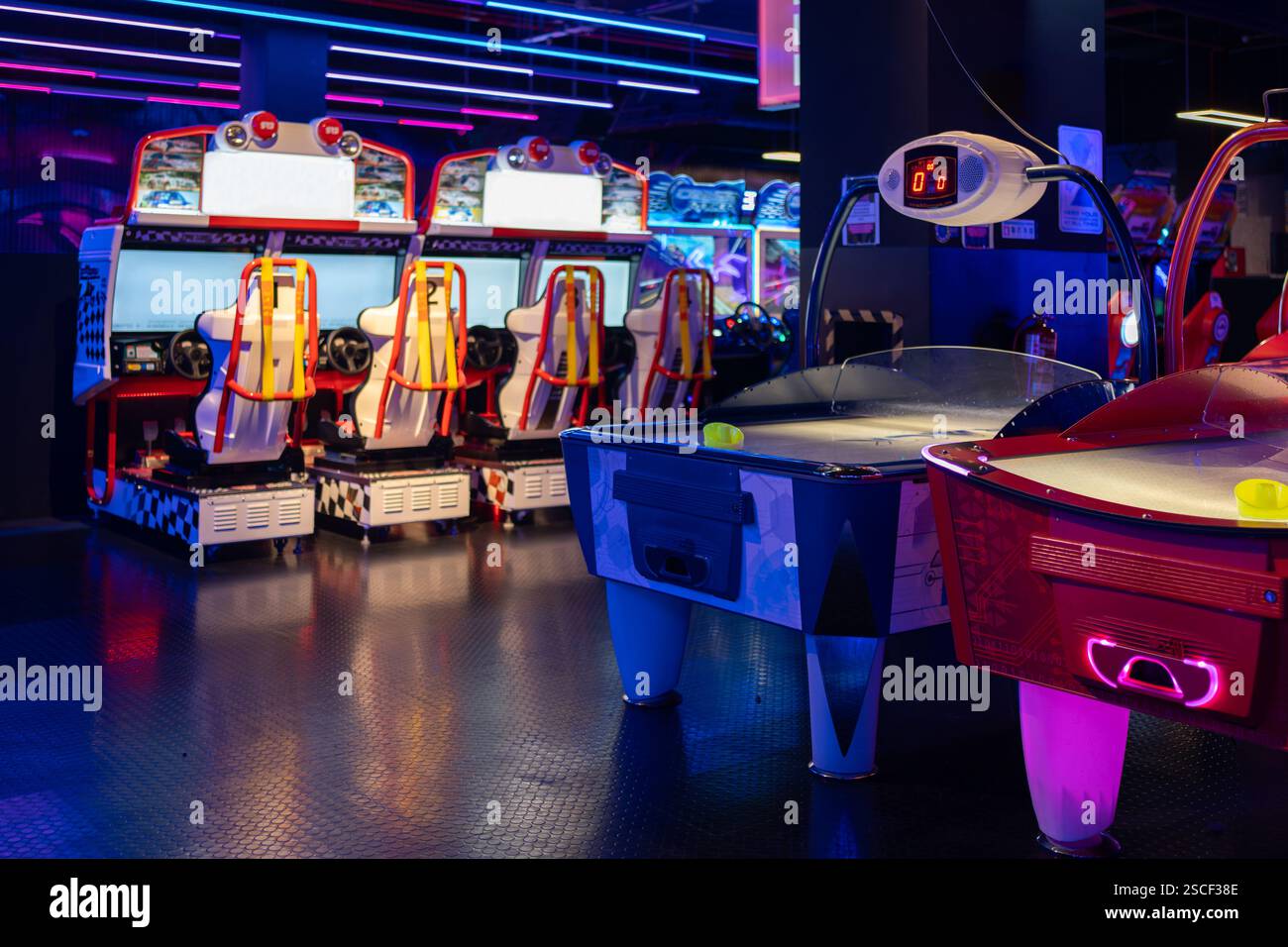 Game Center: Gaming chairs and table in illuminated arcade game zone ...