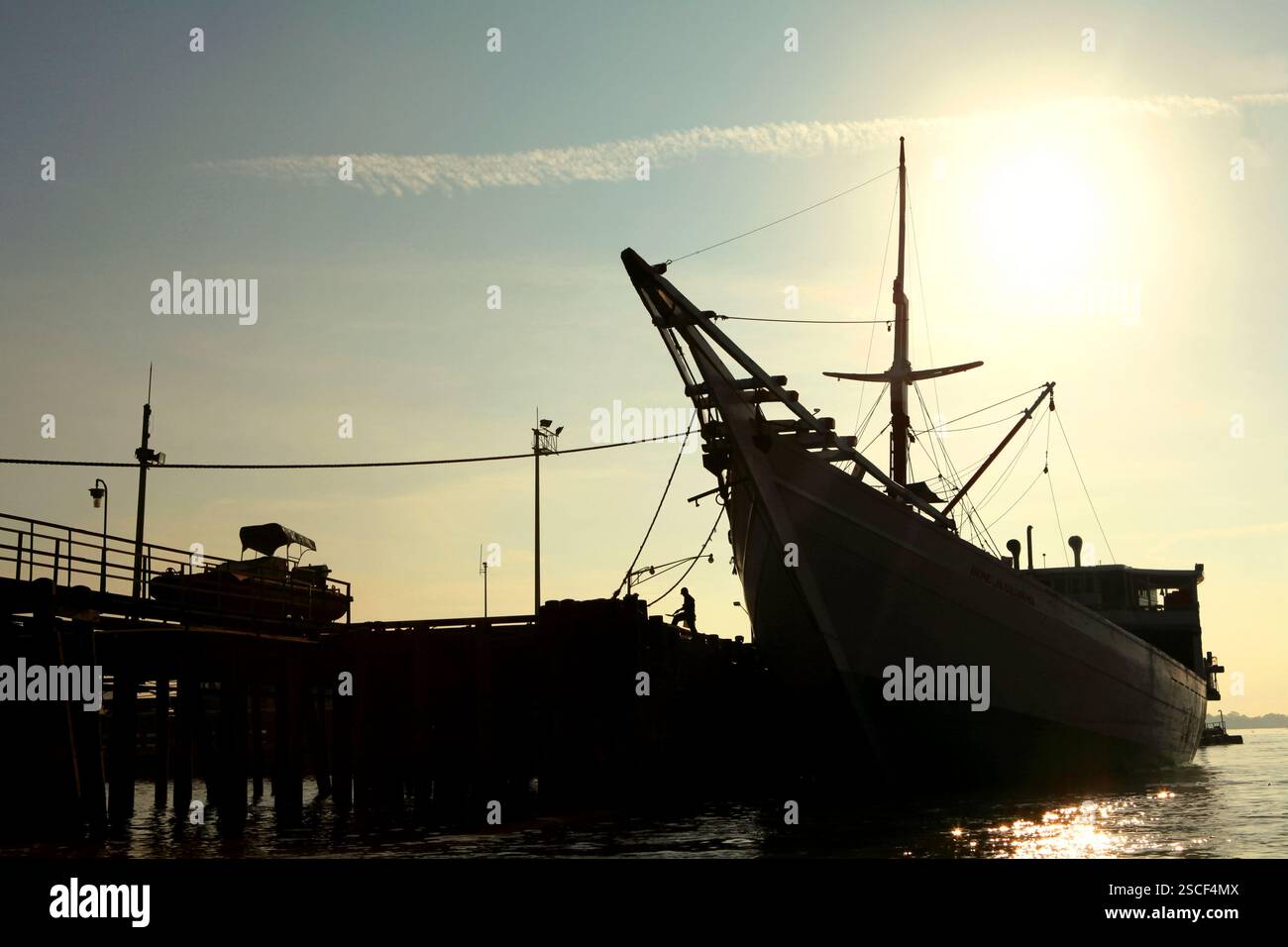 A traditional phinisi ship on a pier on river Musi in Palembang, South ...