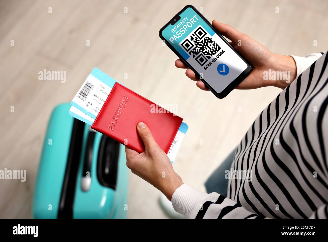 Tourist with passport, flight tickets and mobile phone indoors, above ...