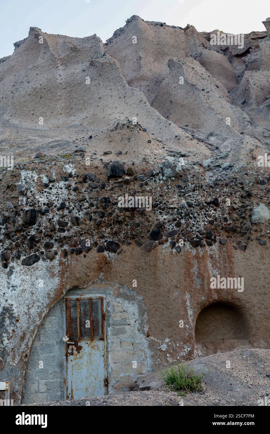 cave houses integrated into a natural rock formation, in Santorini ...