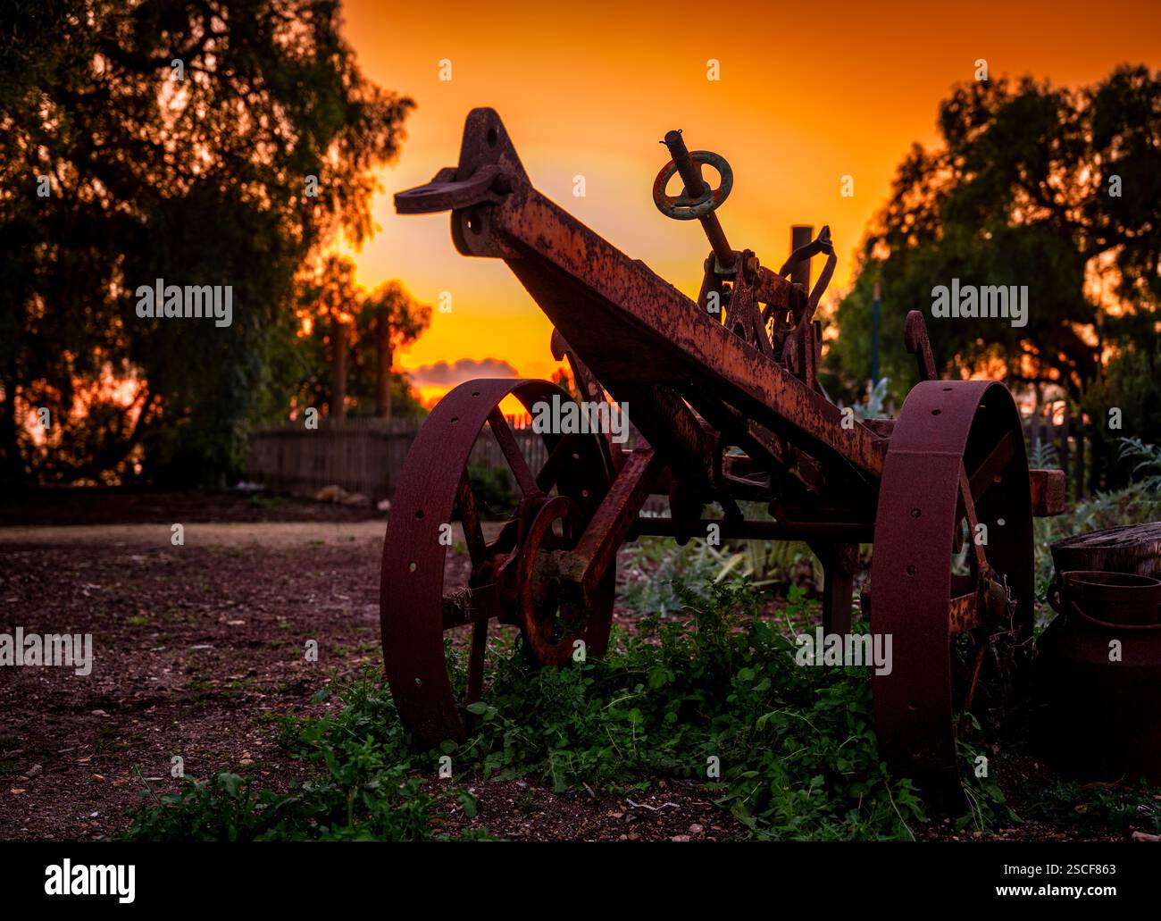 Rusty old farming relic sits in its permanent spot in a garden meadow ...