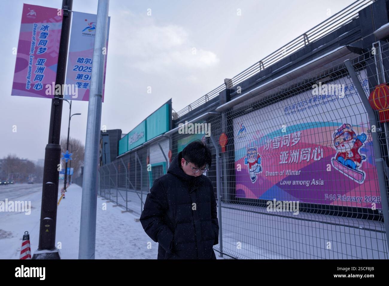 A man walks by a barricaded venue for the opening ceremony of the Asian ...