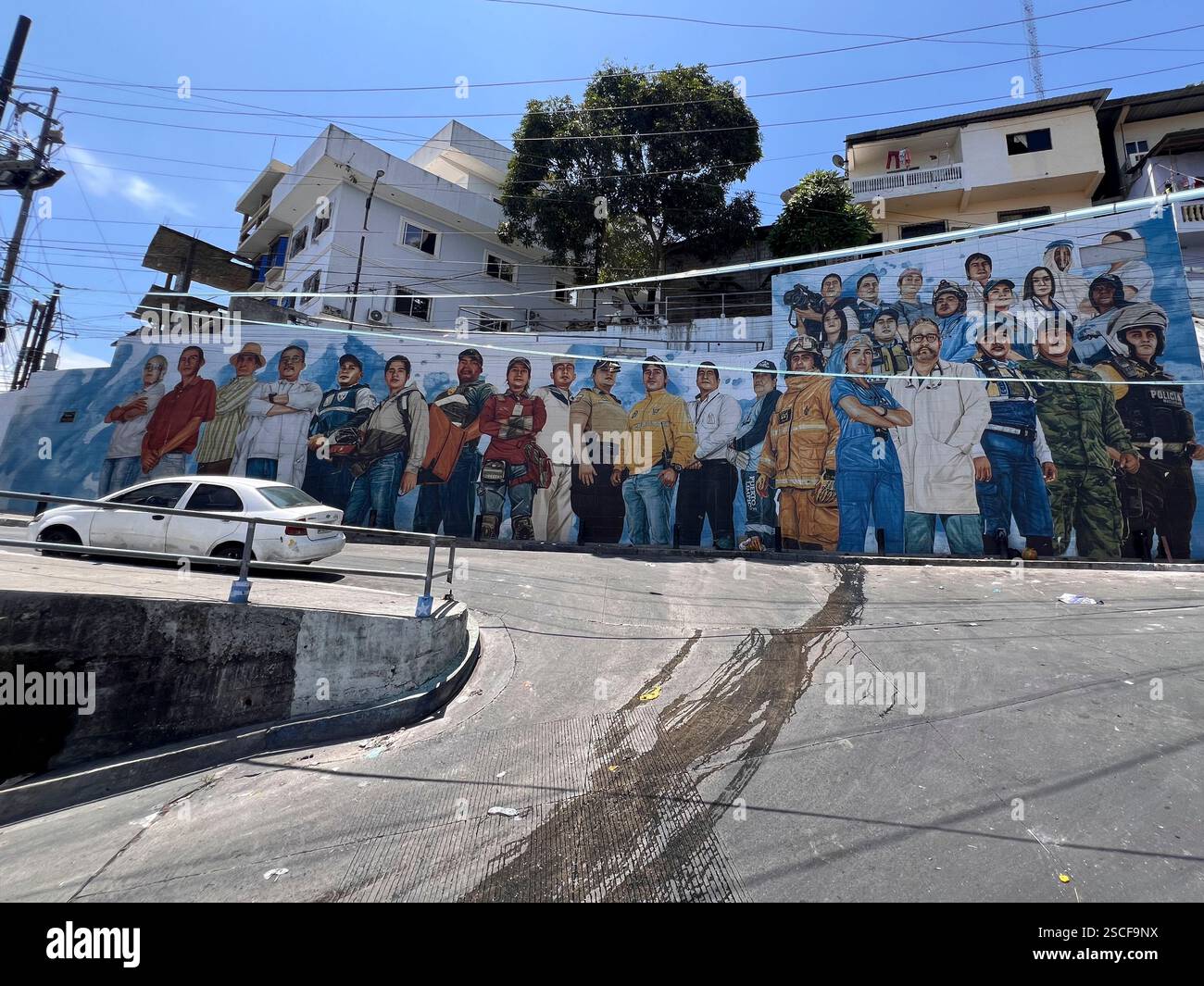 A mural depicting security forces alongside public service workers ...
