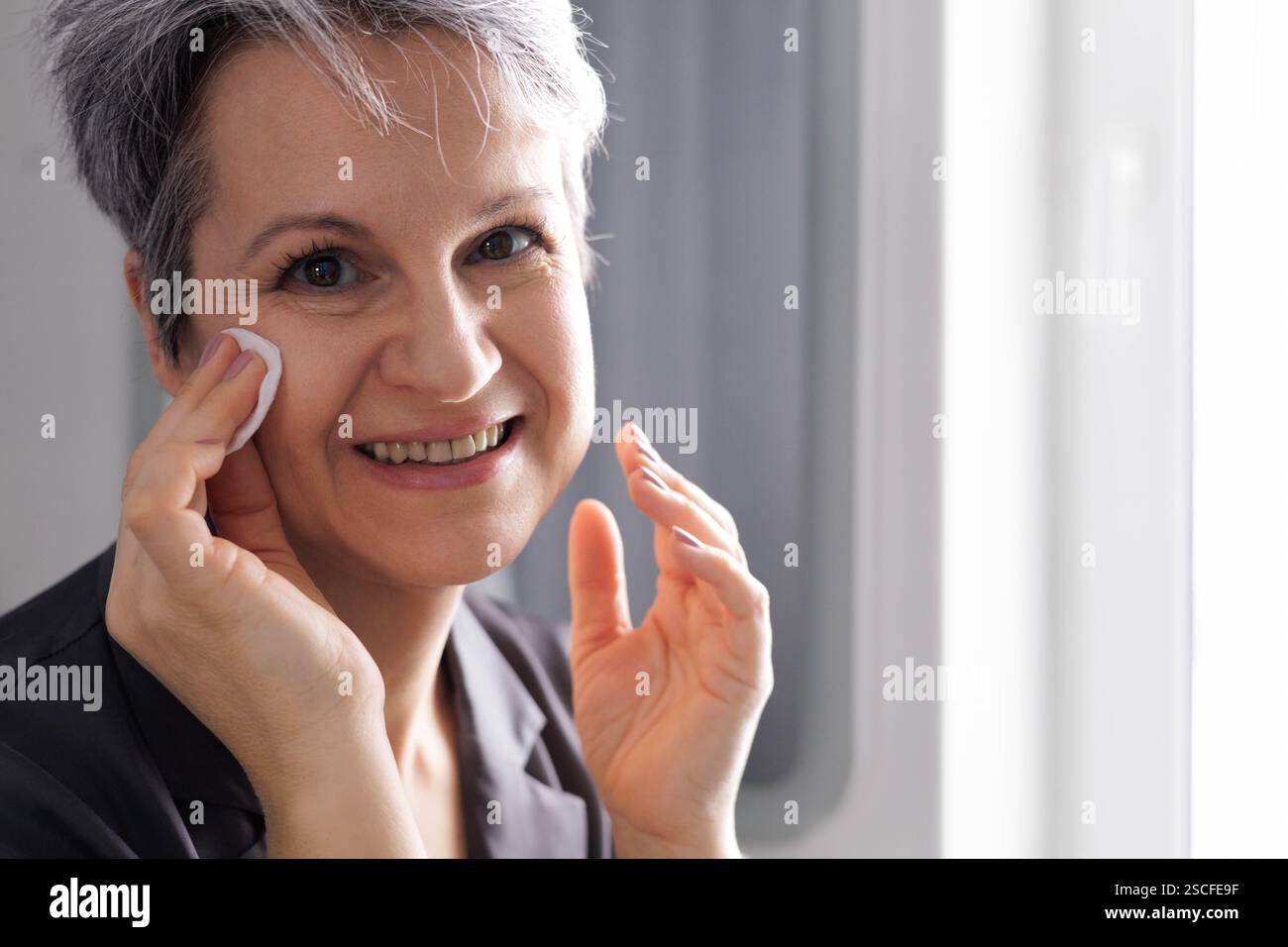 Mature well-groomed beautiful woman during menopause with grey hair ...