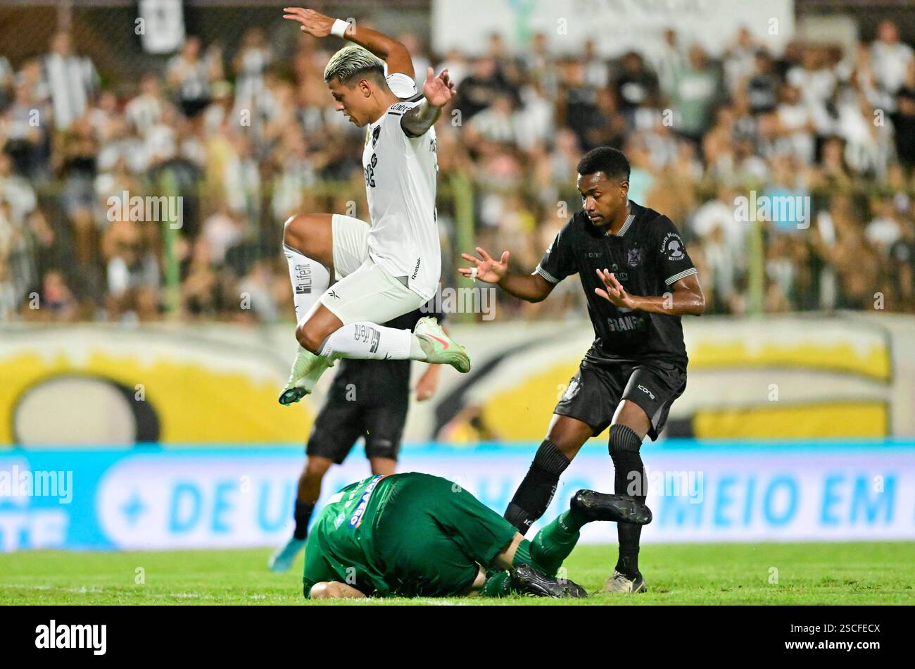 Matheus Martins of Botafogo jumps over Lucas Anselmo Maticoli of Nova ...