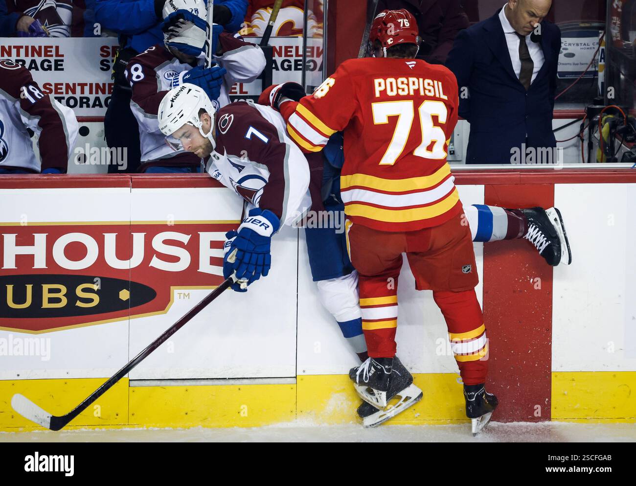 Colorado Avalanche's Devon Toews, left, is checked by Calgary Flames ...