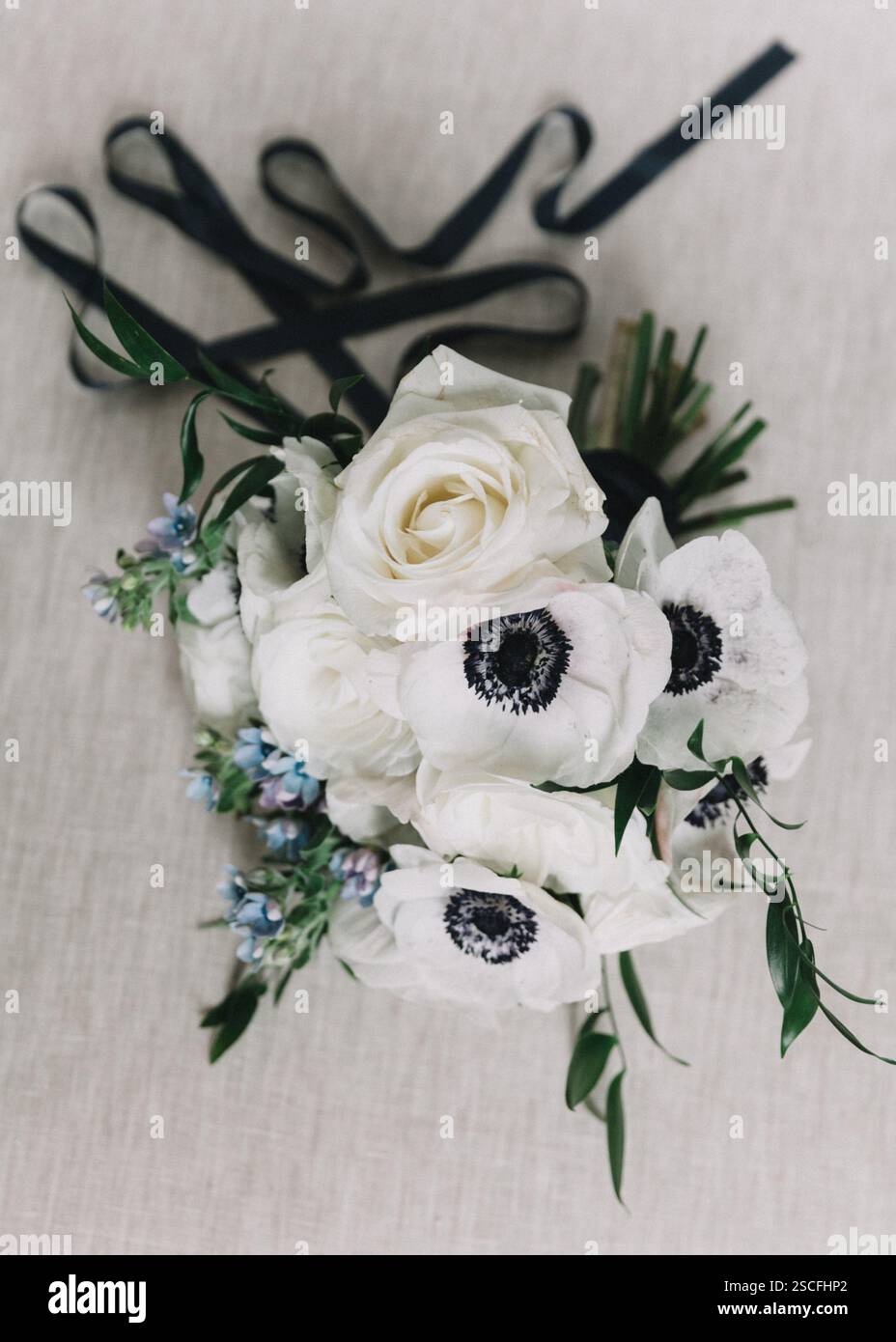 A beautifully arranged bridal bouquet showcases white roses and ...