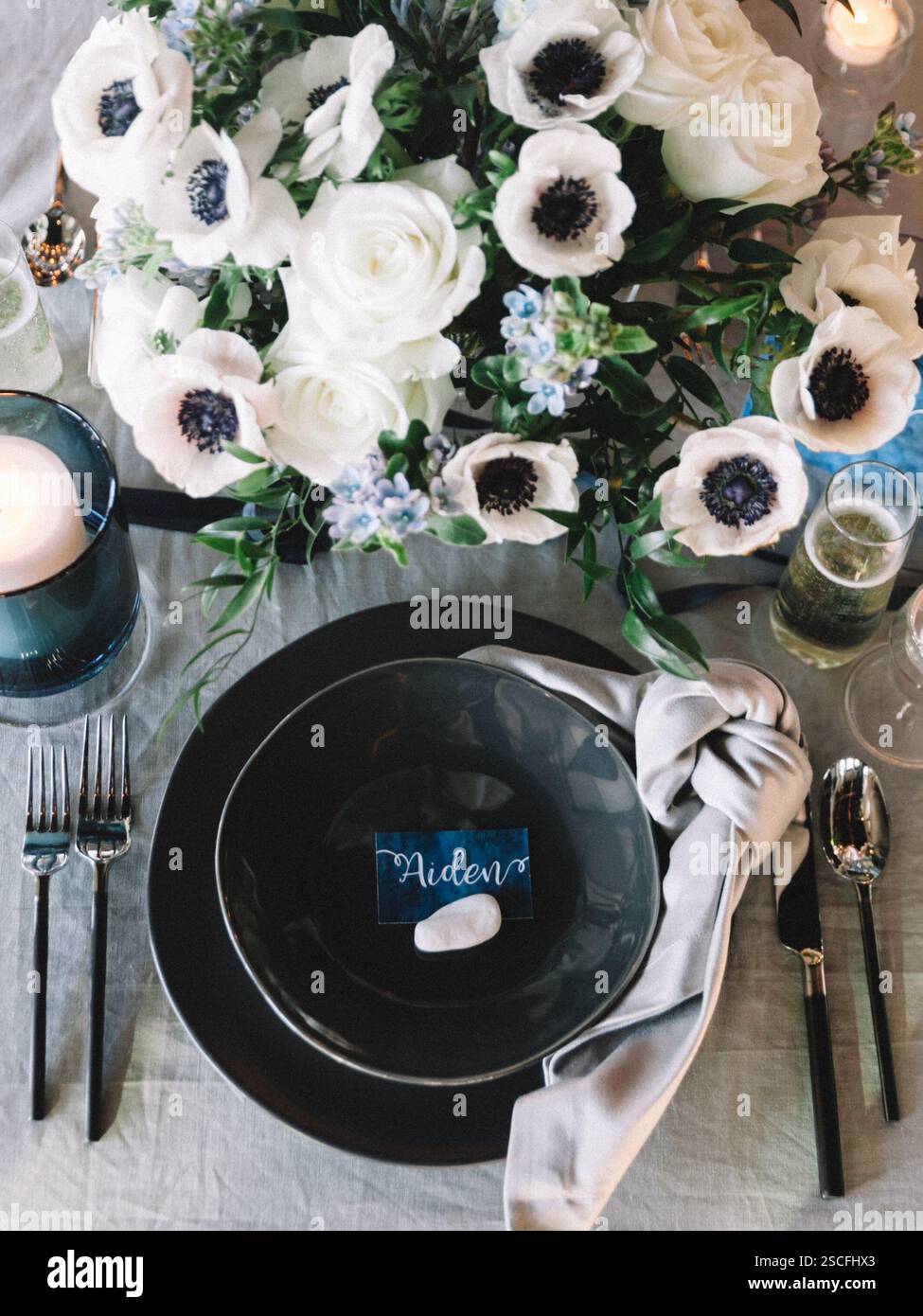 A beautifully arranged dining table showcases a centerpiece of white ...