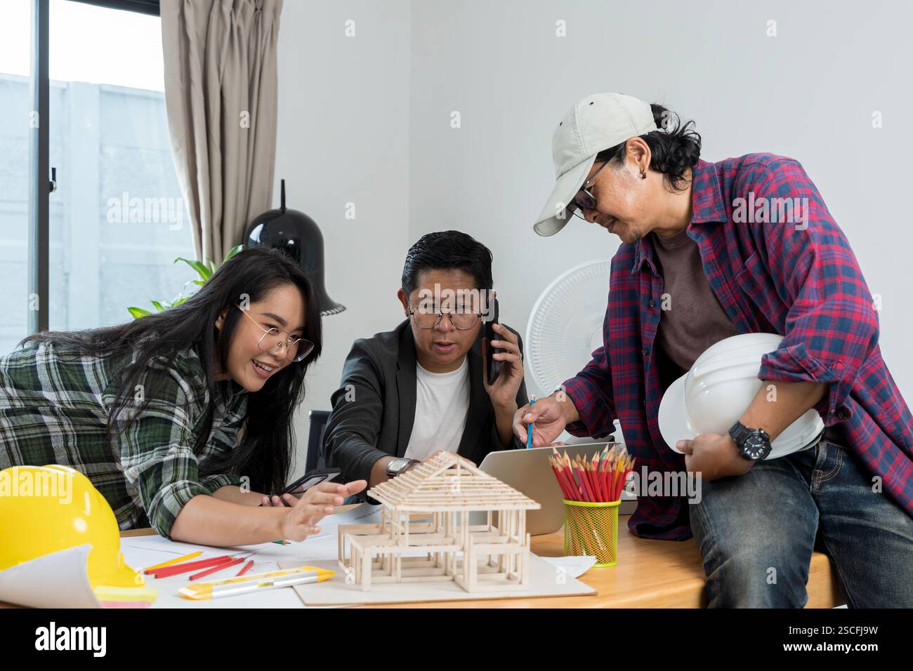 Architect explaining project plan to clients. Confident businesswoman holding architectural ...