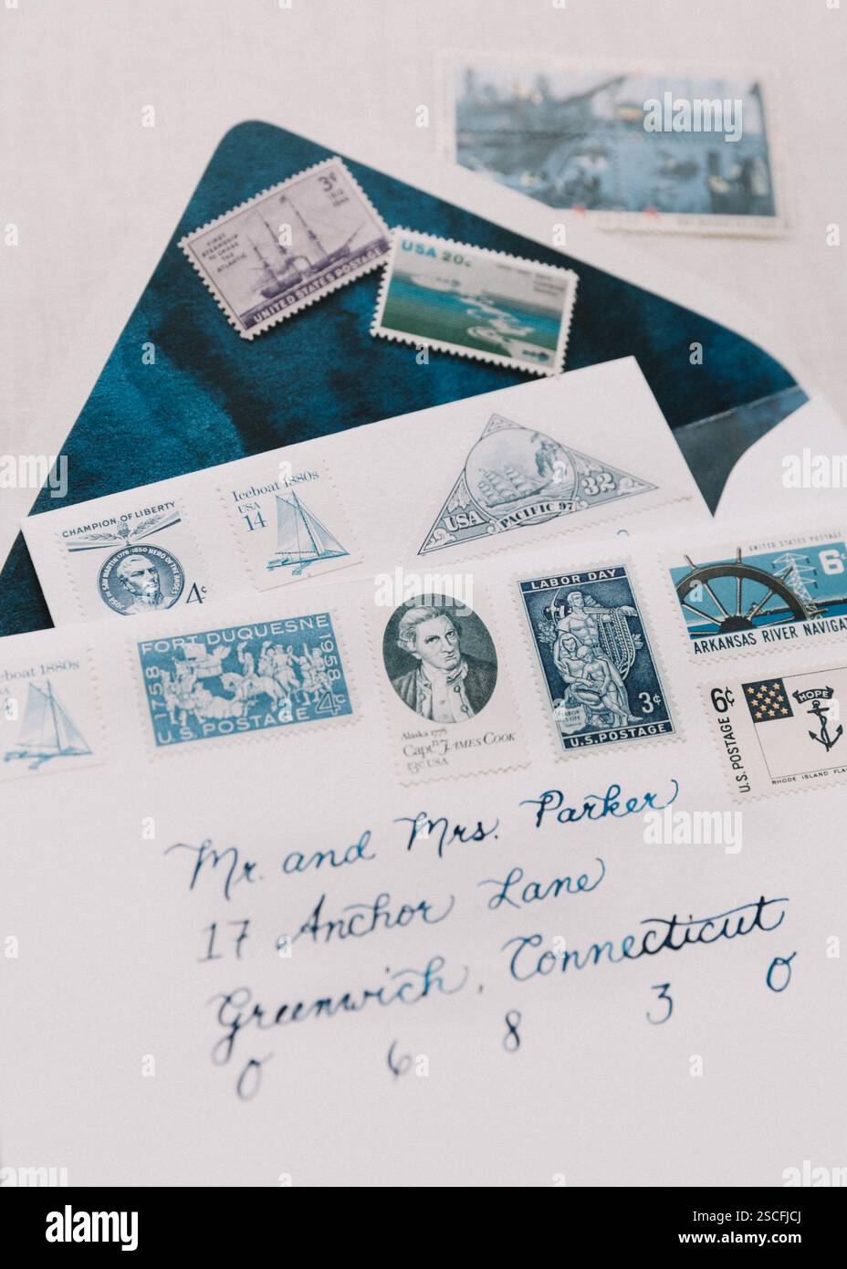 A collection of vintage letters and postage stamps is displayed on a ...