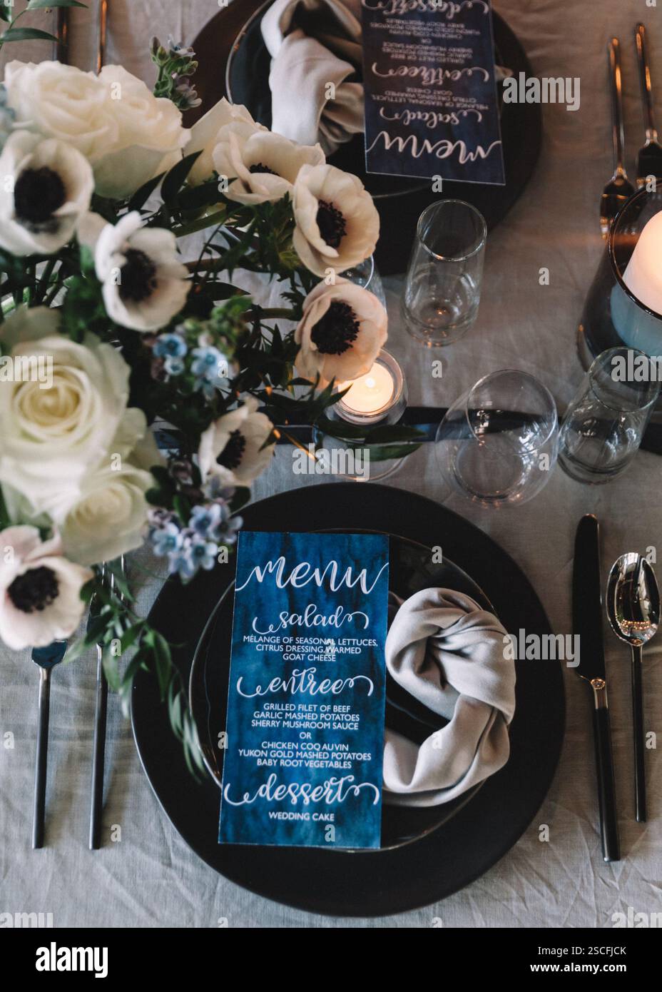 A beautifully arranged wedding table features an elegant floral ...