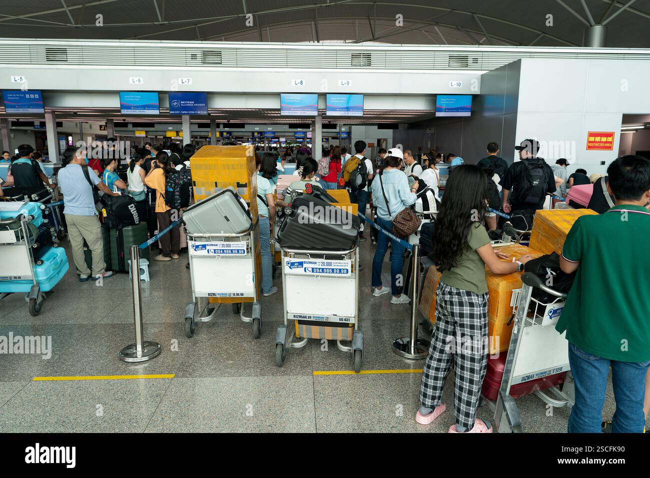 Ho Chi Minh, Vietnam - August 24, 2024: people waiting at the check-in ...